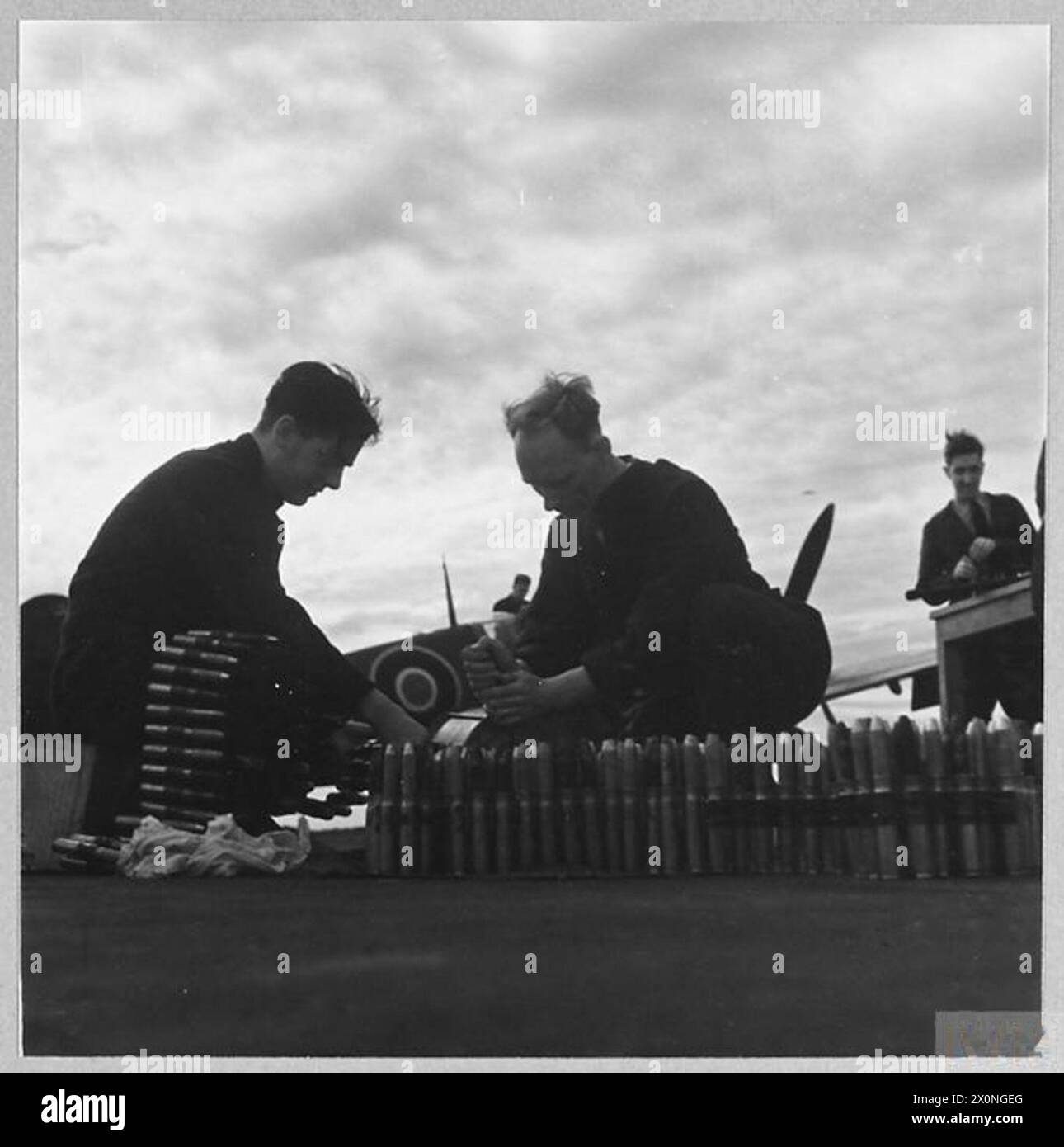 Photograph showing armourers working at a frontline RAF fighter station ...