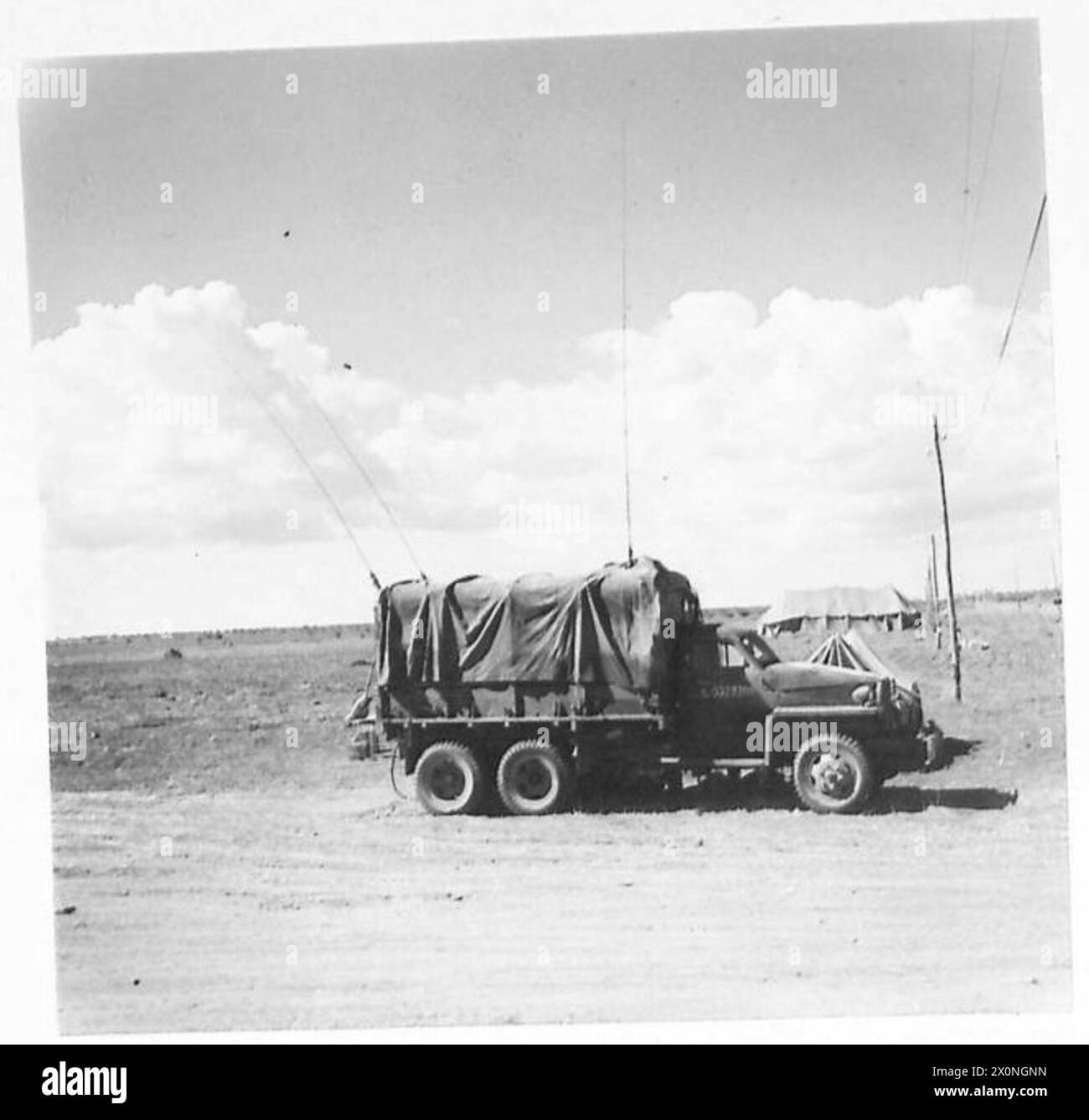 A 12-wheeled Studebaker 2½ ton truck carries two American SCR-399-A ...