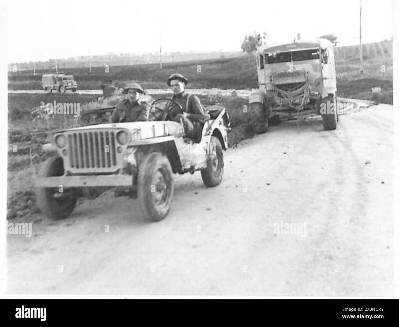 A REME recovery convoy of the Eighth Army moves back onto the road and ...