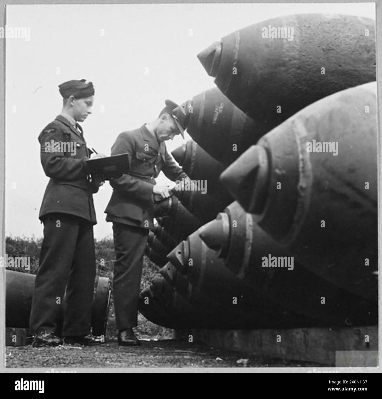 Photograph of an RAF armaments officer inspecting and checking the ...