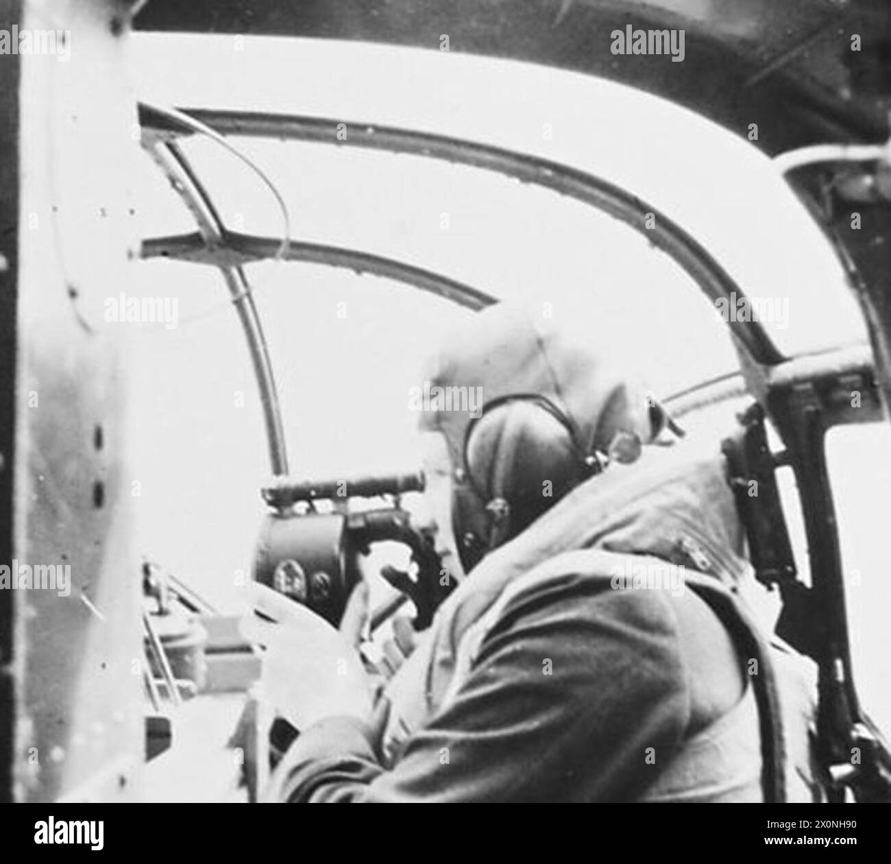 A Beaufort bomber navigator tests an Aldis lamp and prepares charts ...