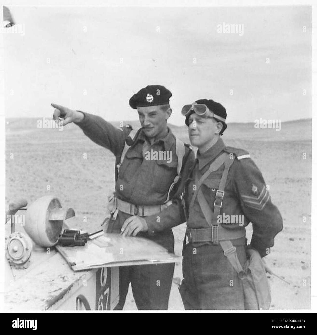 An officer of an armoured unit reviews the day's route with a Sergeant ...