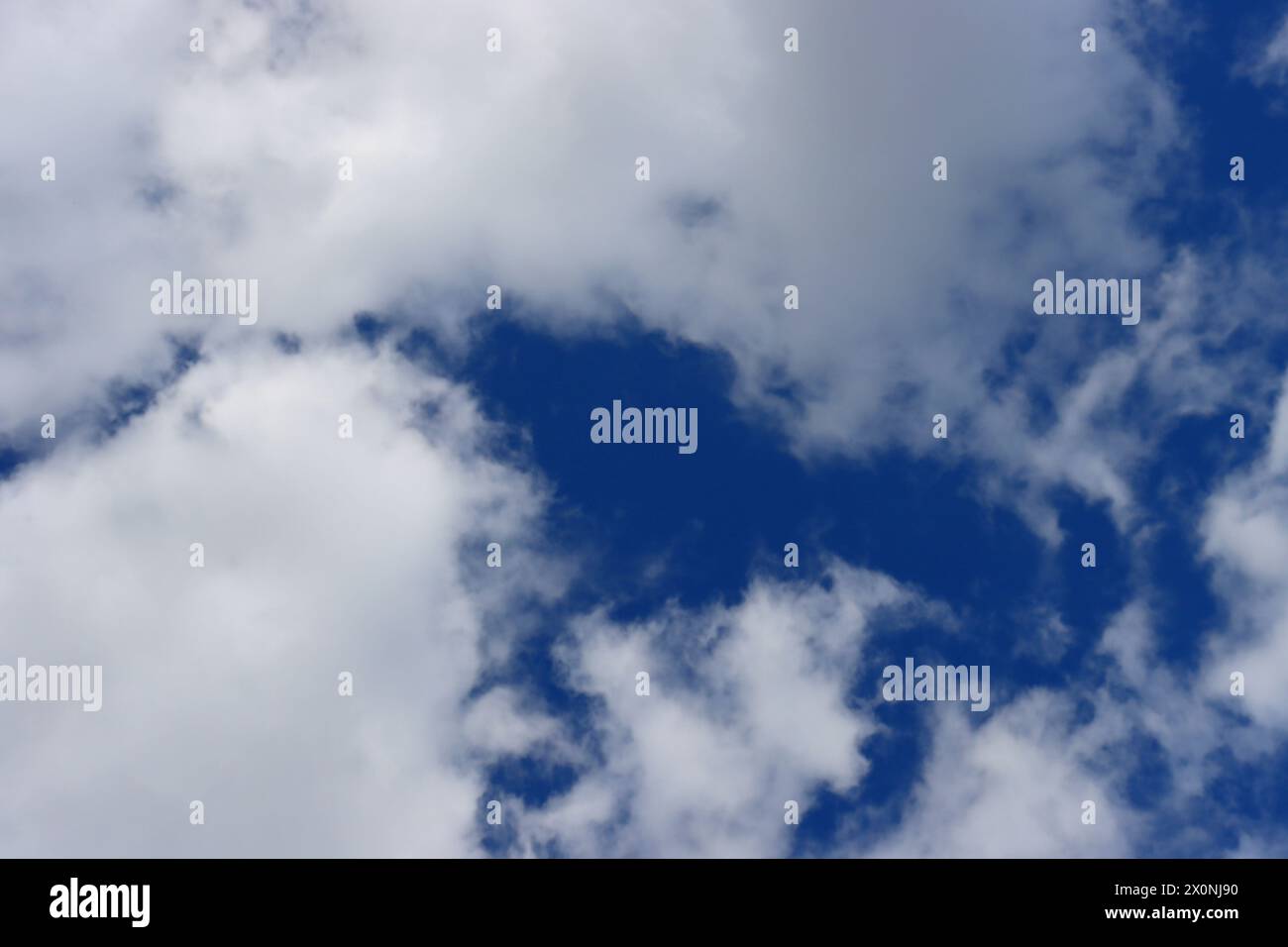 white clouds disappear in the hot sun on blue sky. Time-lapse motion ...