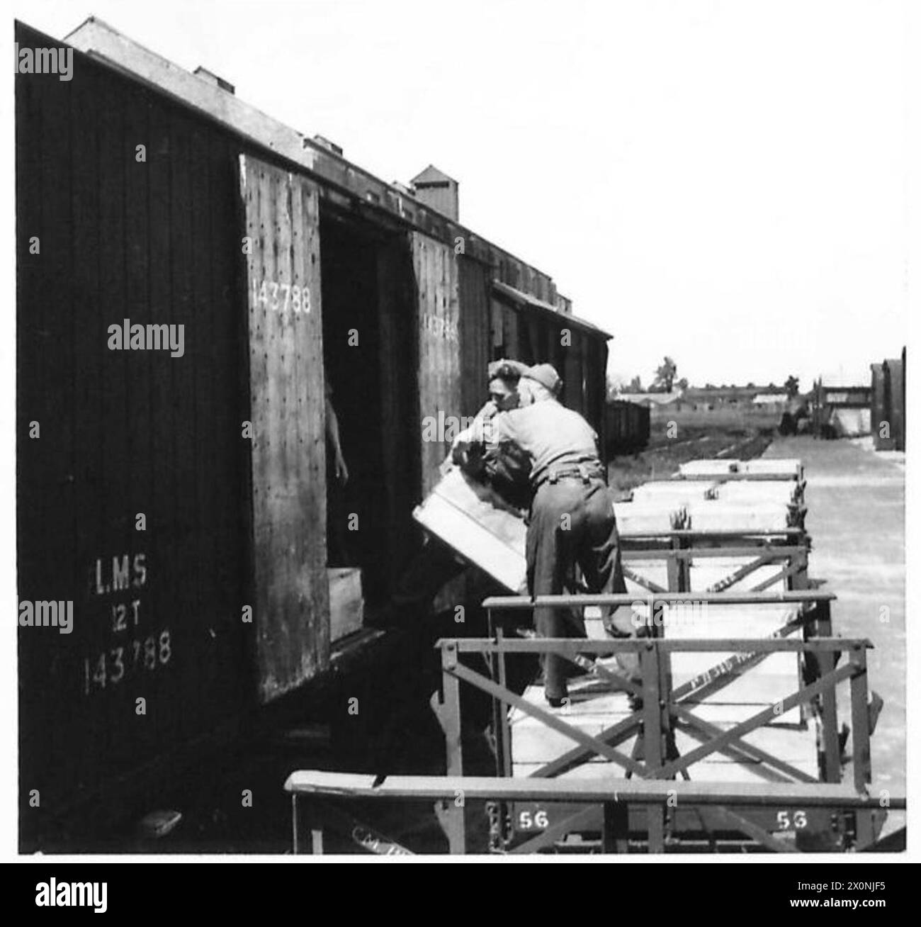 Photograph showing British Army personnel unloading cased food supplies ...