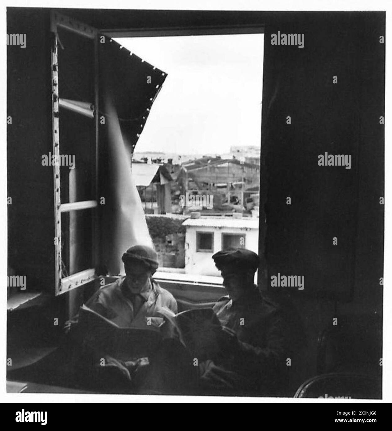 British Army troops are reading in the YMCA reading room in Tobruk ...