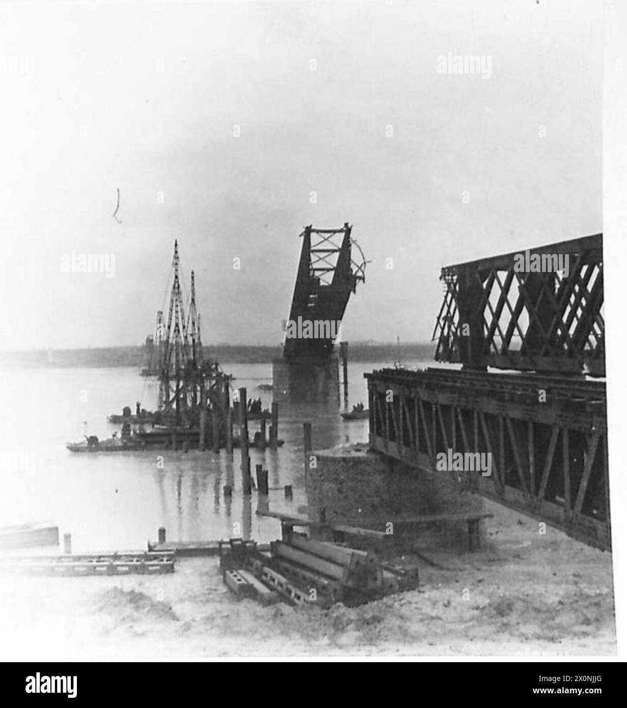 Pile drivers and sunken piles are visible in the River Po as a new ...