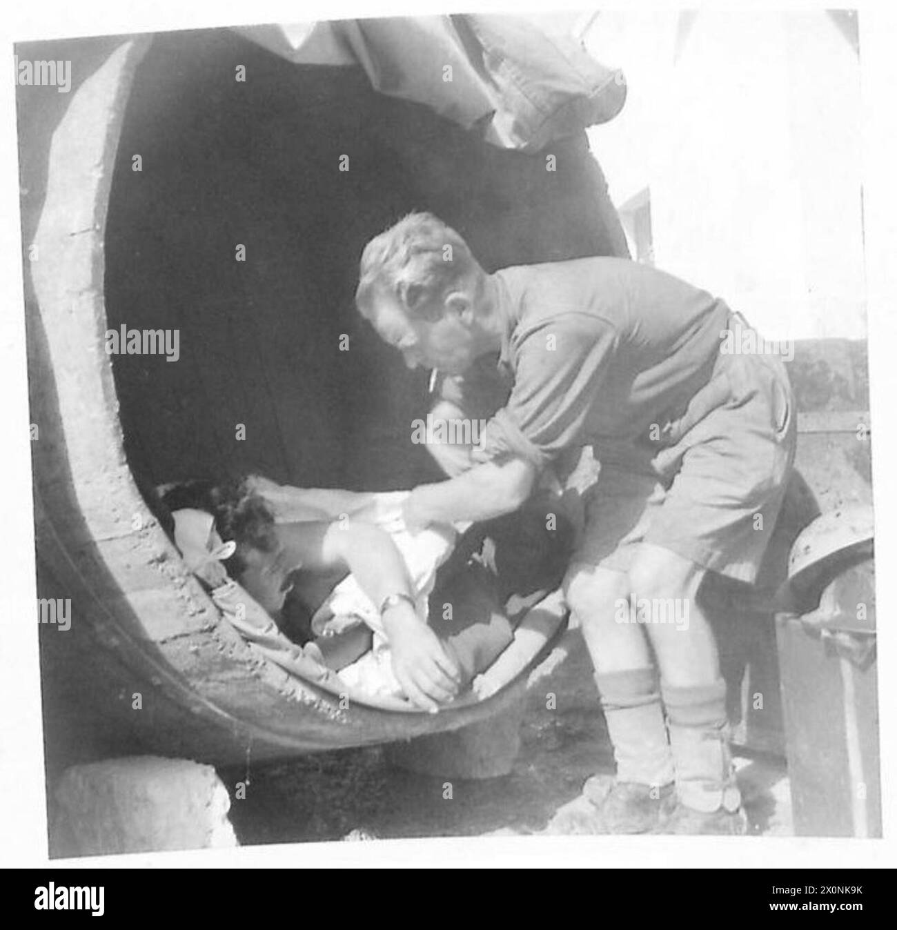 Two Eighth Army men converted large Vino barrels into winter quarters ...