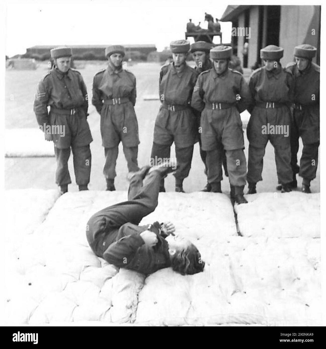 Paratroop recruits receive instruction from RAF instructors on proper ...