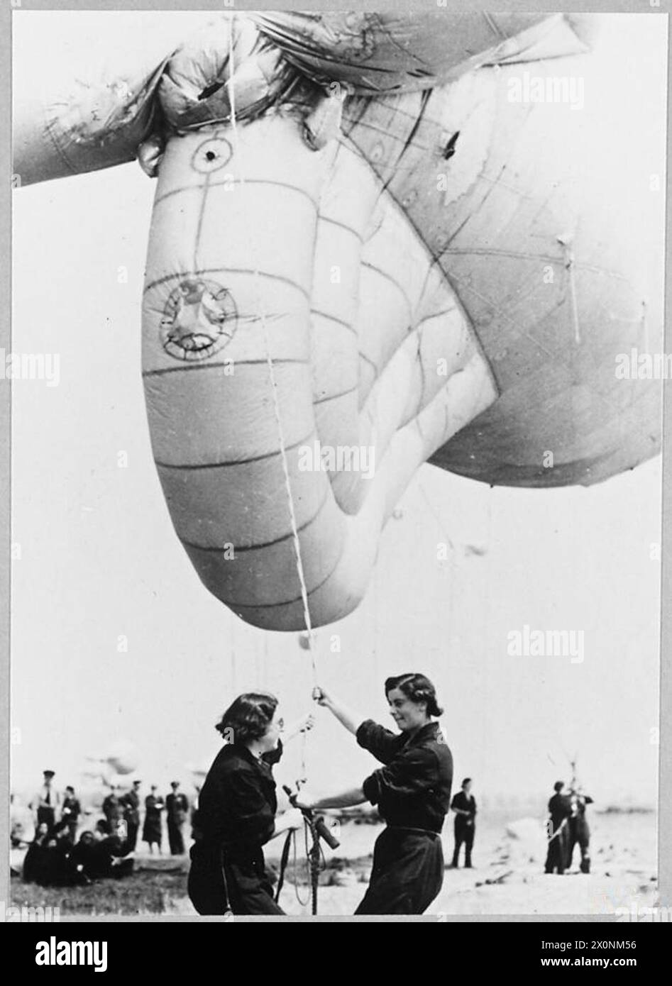 PULLING THEIR WEIGHT - W.A.A.F. balloon operators mooring the tail line ...