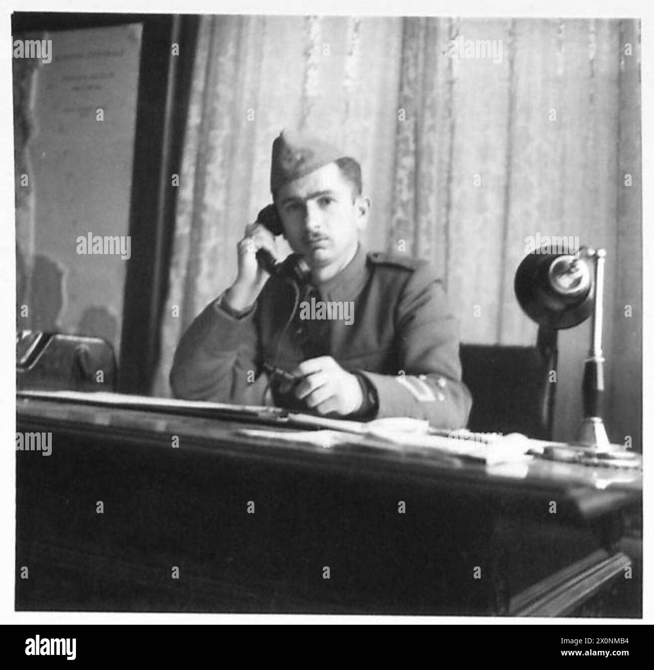 Colonel Hysni Kapo of the British Army uses an office telephone during ...
