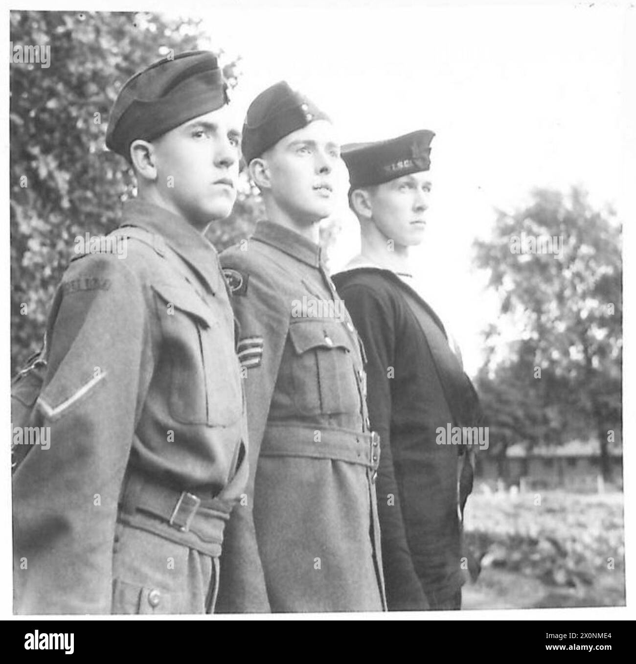 Army cadets are shown marching in camp, led by twins H.J. Millman and E ...