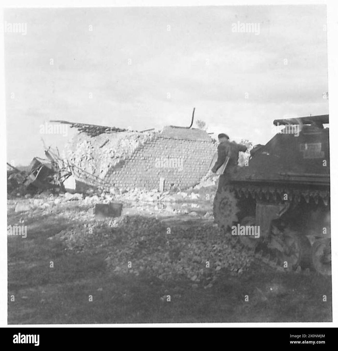 A Sherman tank from the Fifth Army arrives at a destroyed bridge; a ...