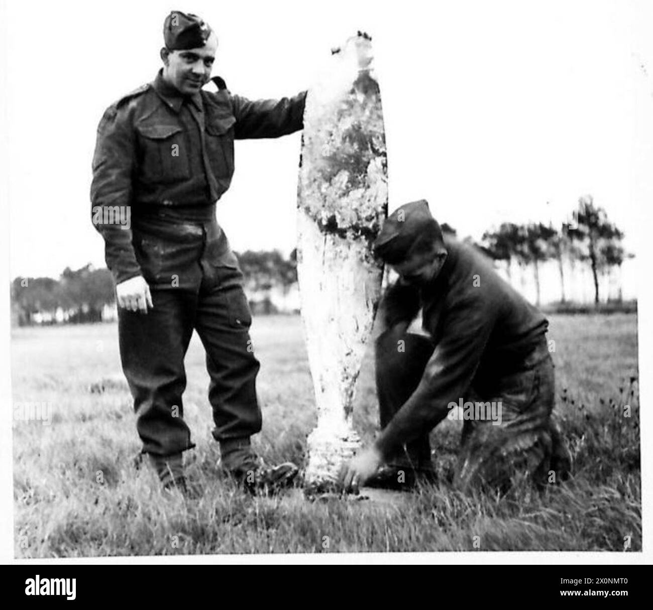 Anti-aircraft gunners inspect a blade from the propeller of a crashed ...