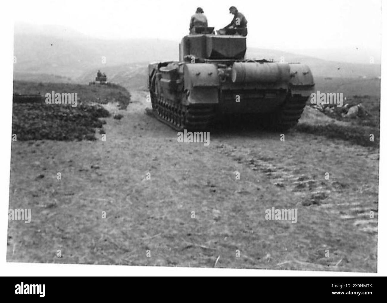 WITH THE EIGHTH ARMY (VARIOUS) - Churchill tanks moving up the hillside ...