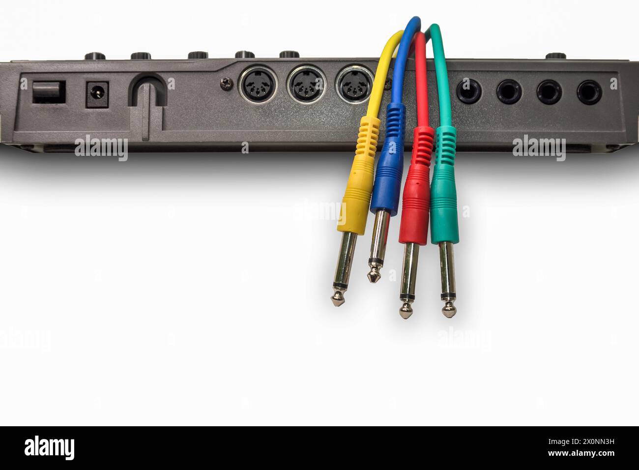 Audio jack plugs and music device on a white background with copy space ...