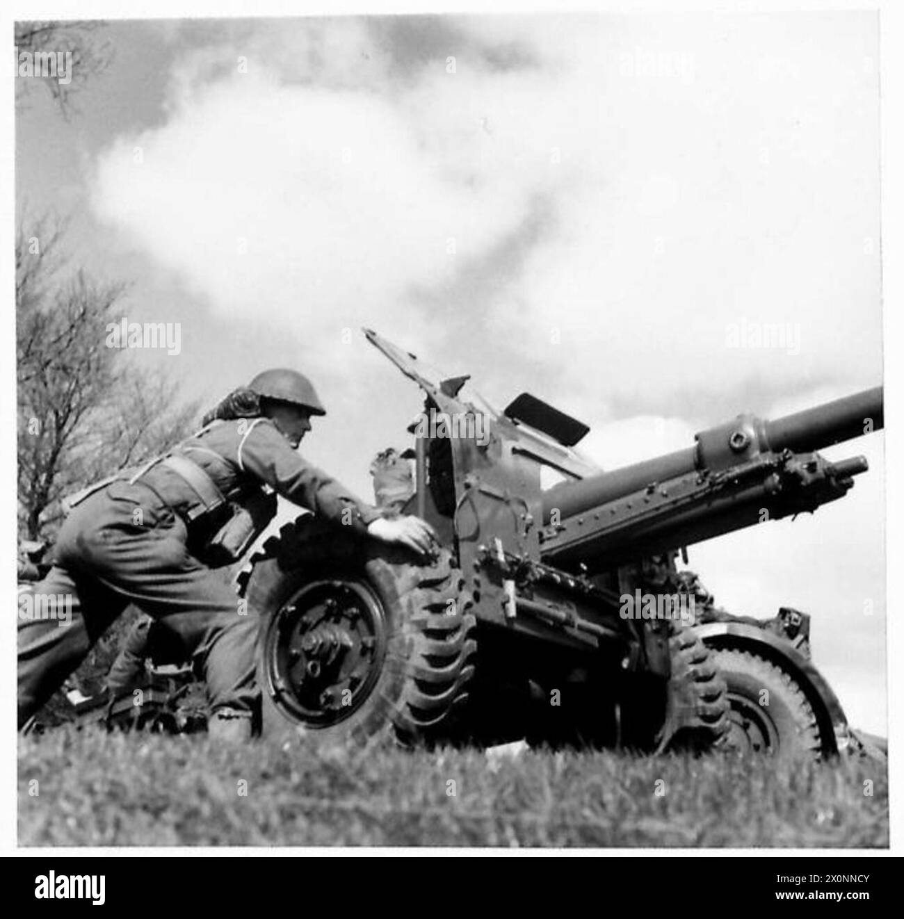 A 25-POUNDER SHOOT - Manhandling one of the guns into position ...