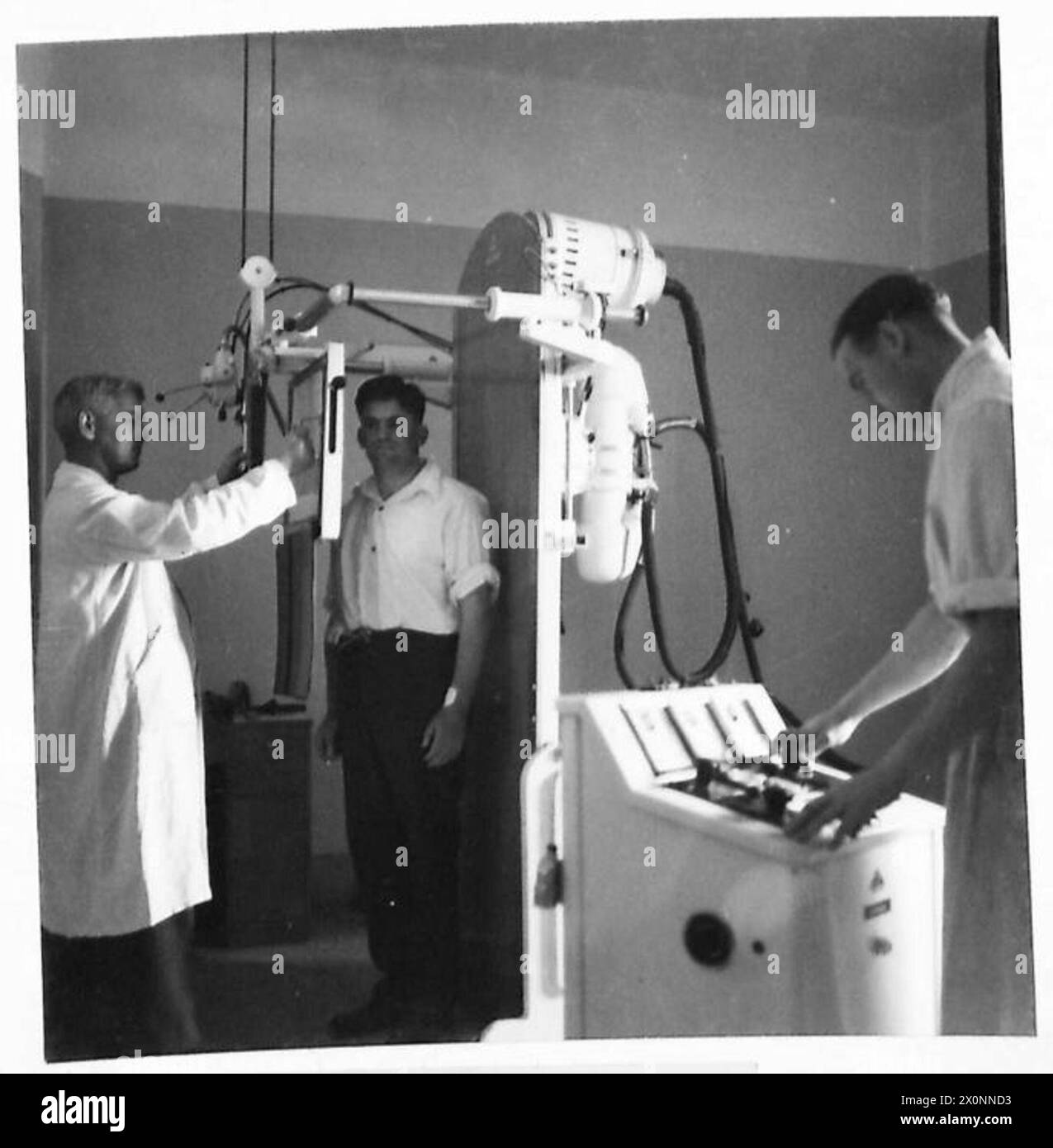 A radiologist screens a patient for shrapnel in a well-equipped X-Ray ...
