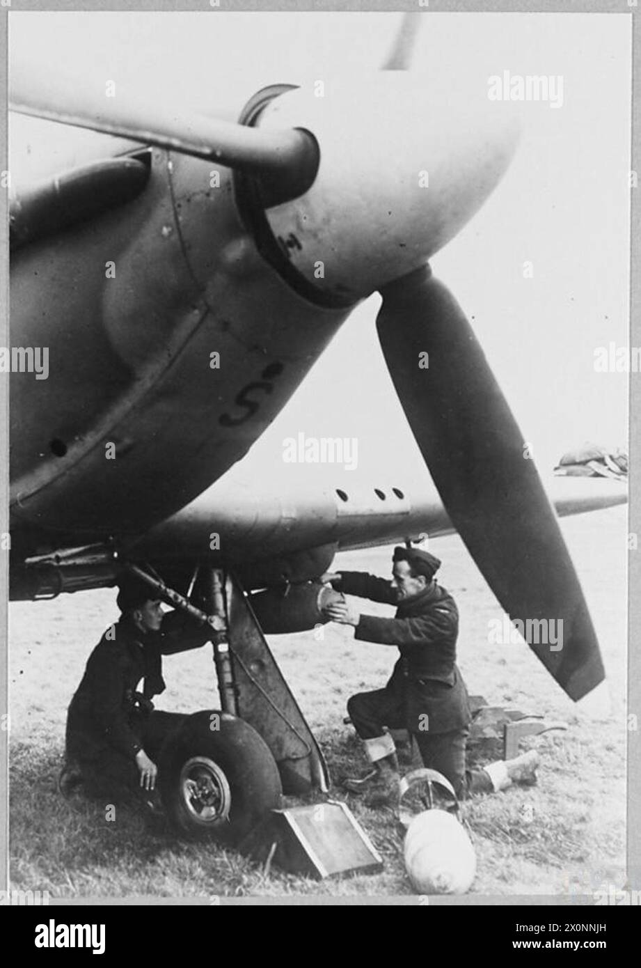 BRITISH HURRICANE FIGHTERS CARRY BOMBS - Loading bombs on a British Hurricane fighter ...