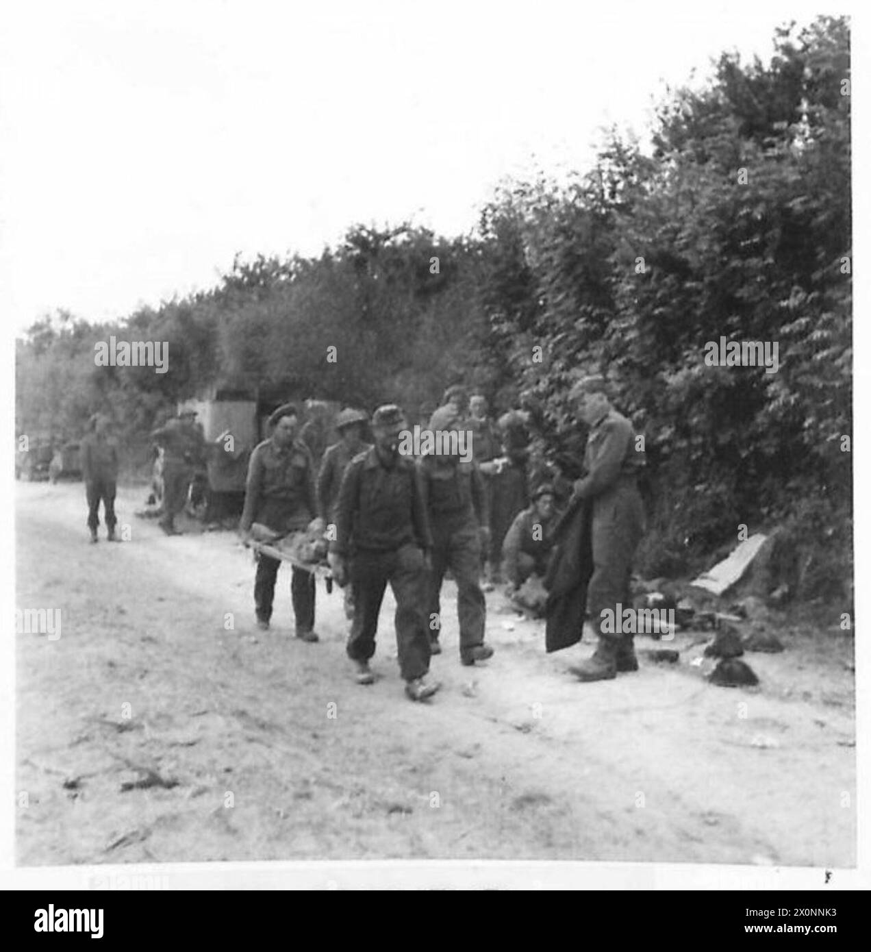 WITH OUT TROOPS IN NORMANDY - A German casualty being carried to an ...