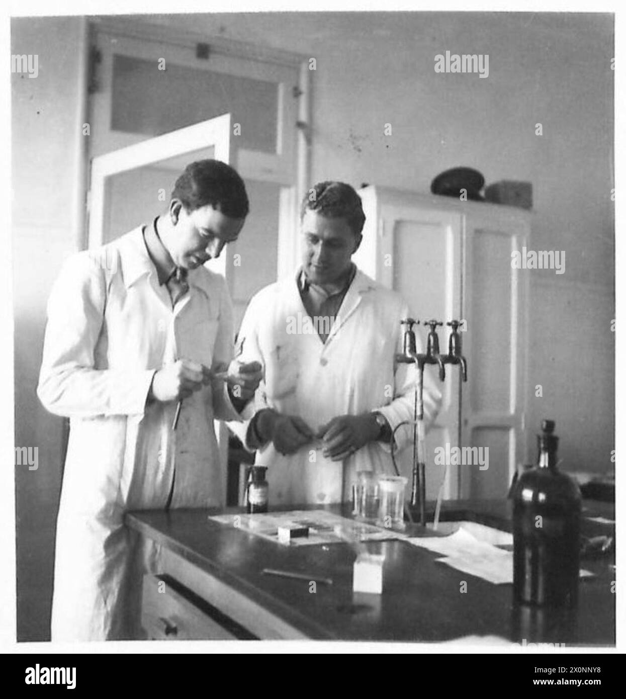 A pathologist works in a fully equipped laboratory examining and ...