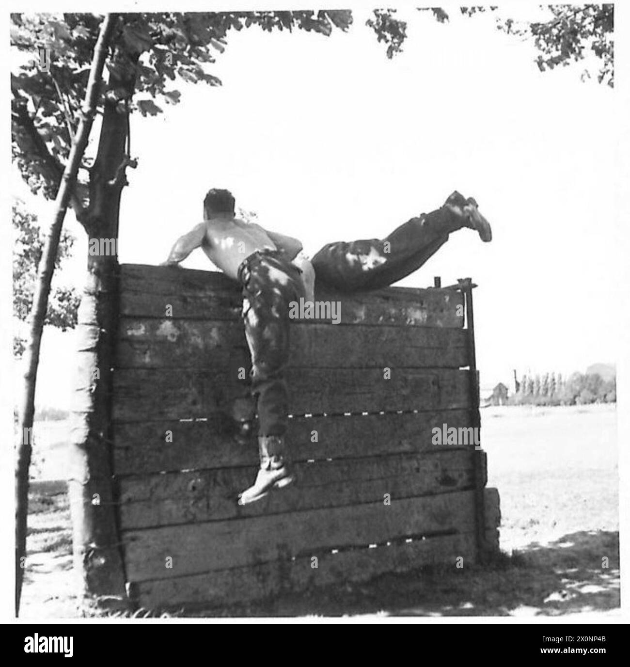 PHYSICAL TRAINING SCHOOL AT HENDON - Surmounting six-foot wall (left ...