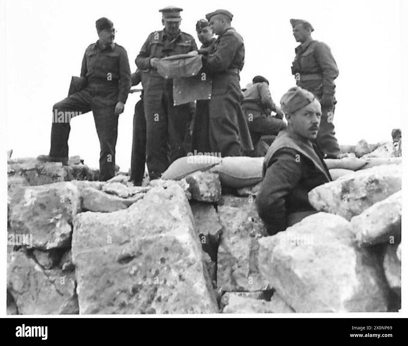 General George Edwin Brink studies a map with Polish officers at Gazala ...