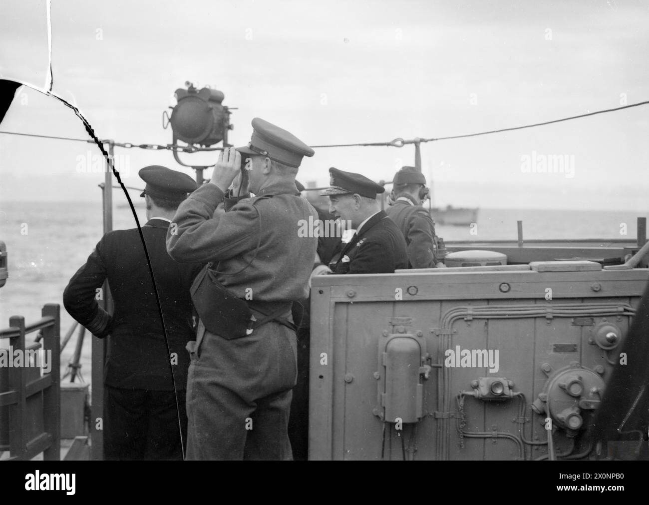 Rear Admiral Sir Harold Burrough and naval and army officers oversee ...