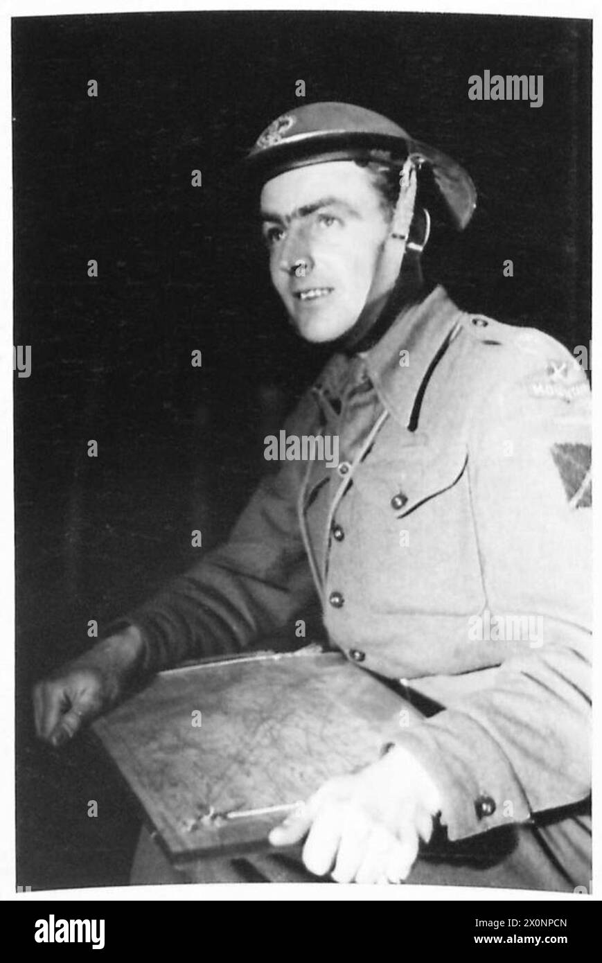 RHINE CROSSING - An Infantry officer studies his maps in the light of ...
