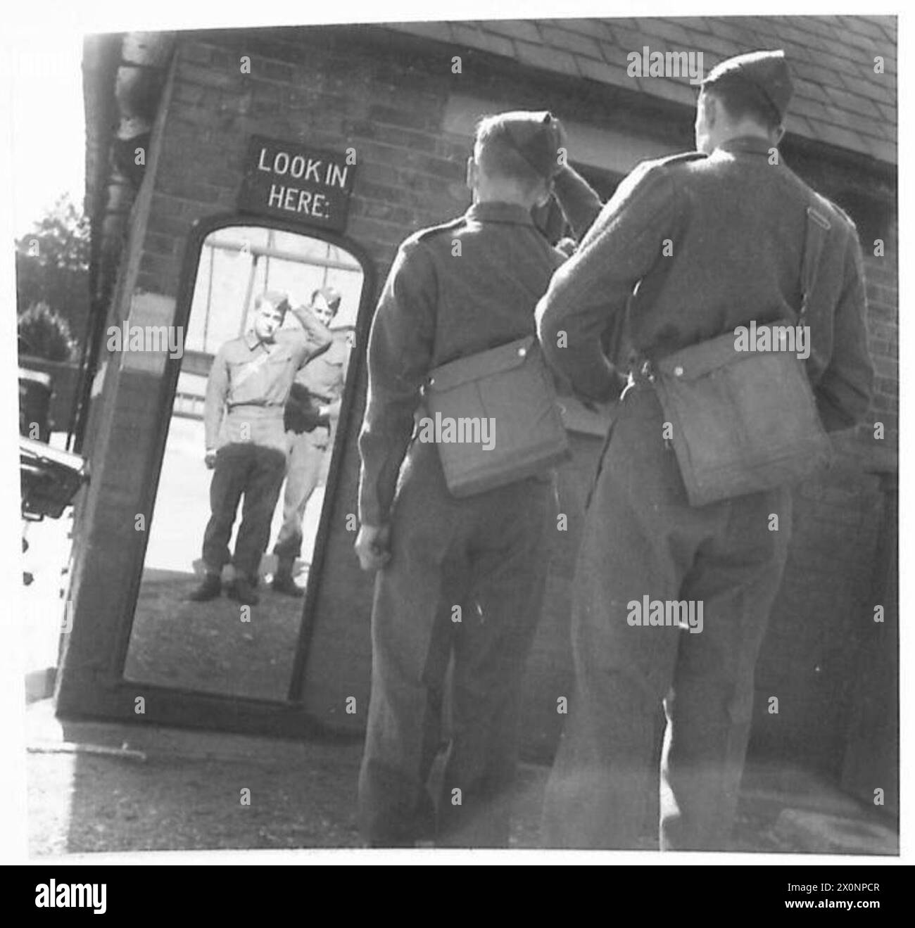 Infantry soldiers are pictured checking their appearance in a mirror ...