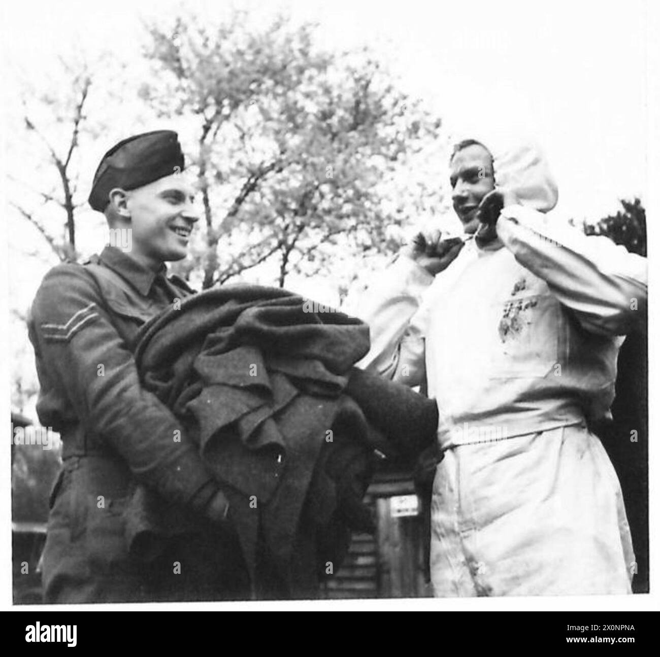 Photographic negative showing a soldier wearing a disinfester hood ...