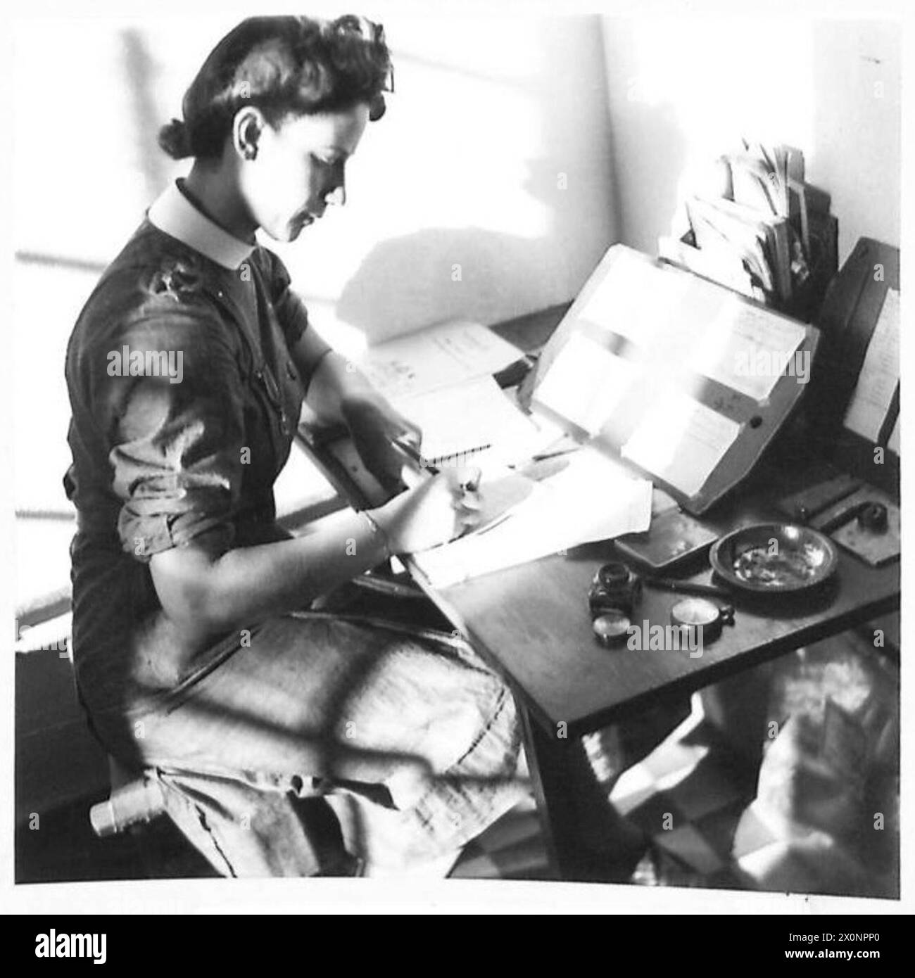 A nurse in North Africa records patient temperature charts as part of ...