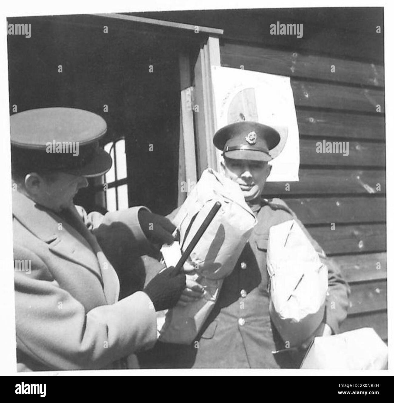 An officer inspects parcels prepared for Military Police prisoners of ...