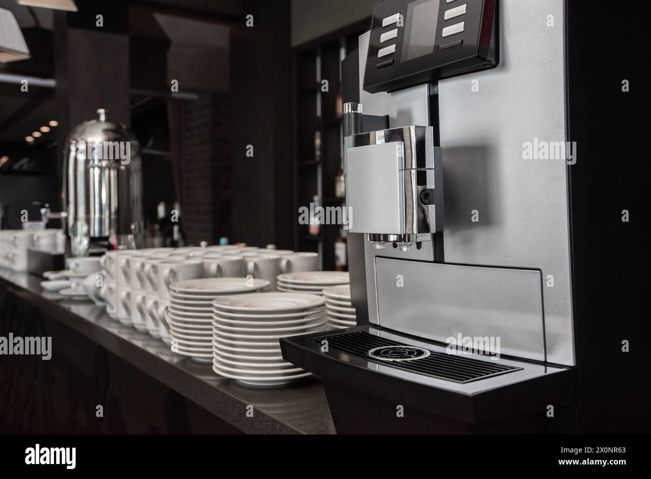 Automatic coffee machine against the background of blurred interior ...