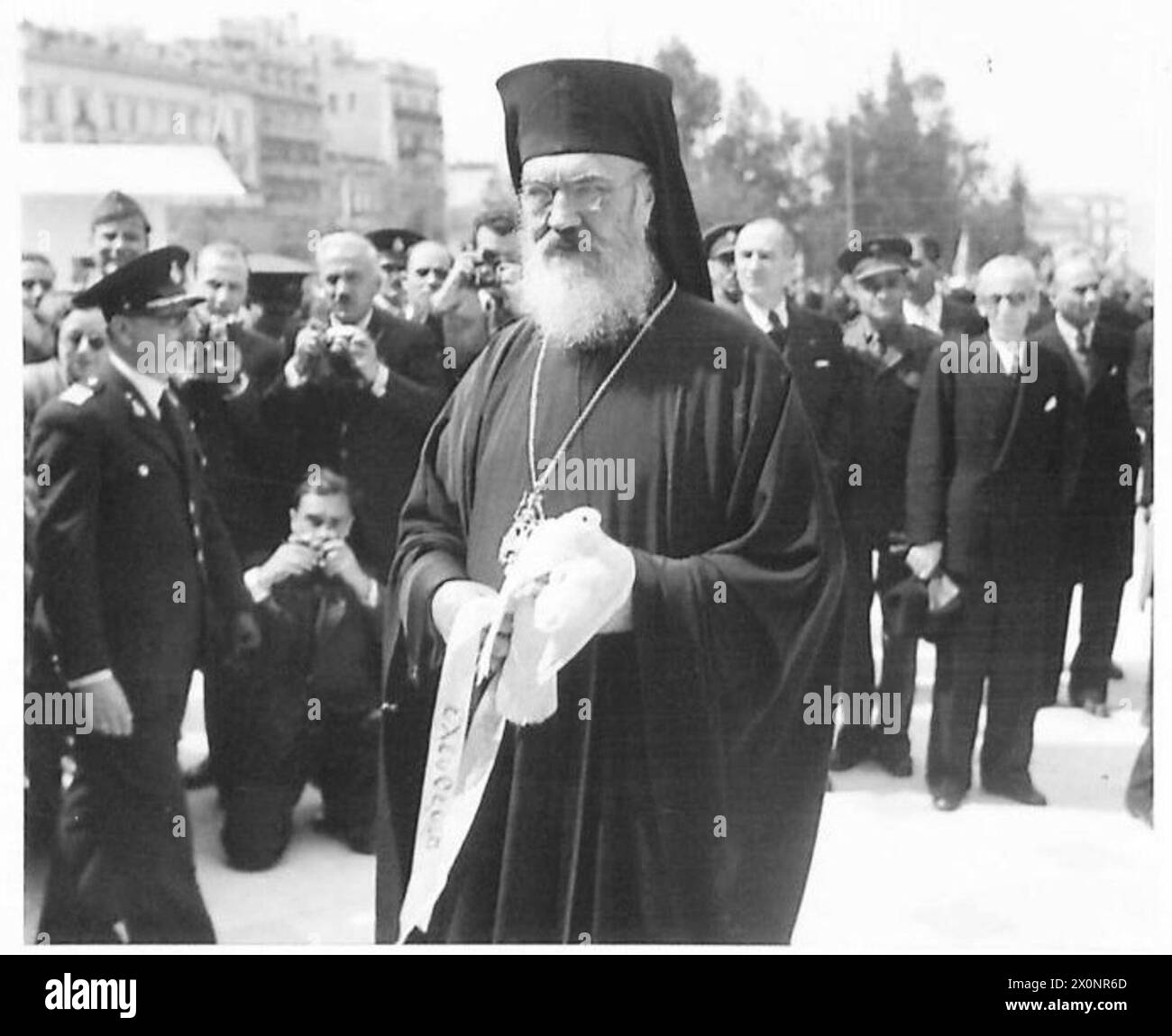 Photograph shows Archbishop Damaskinos holding a dove presented by a ...