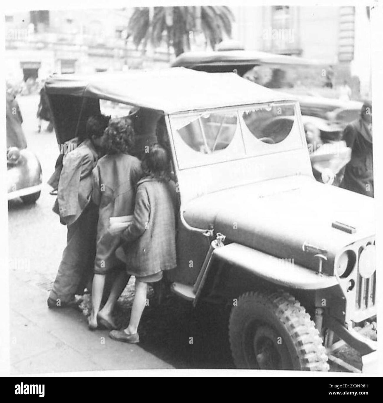 ITALYLIFE IN ALLIED-OCCUPIED NAPLES - A Jeep pulls in to the curb, and ...