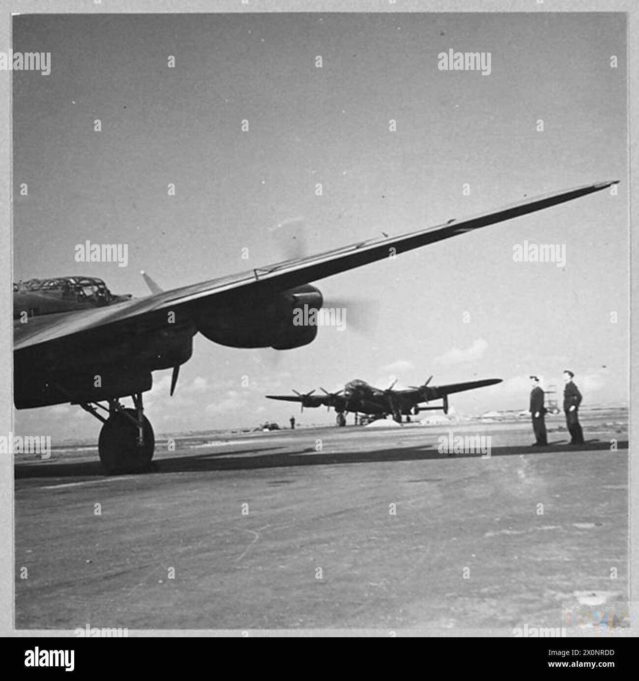 Lancaster bombers and their crews are prepared for a mission to ...