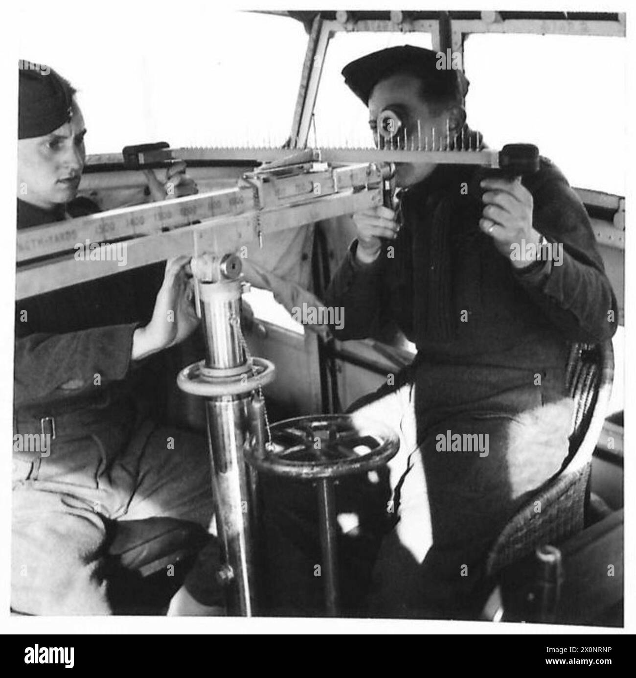 A range officer and assistant use a 'rake' device to calculate shooting ...