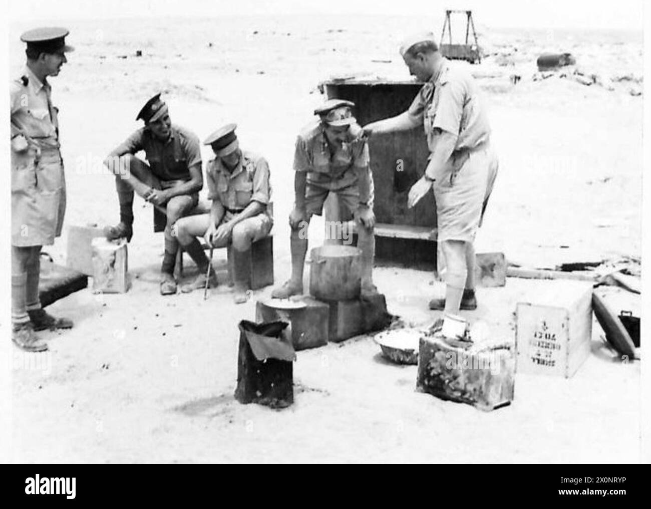 A desert improvised cookhouse is pictured near British Army light tanks ...