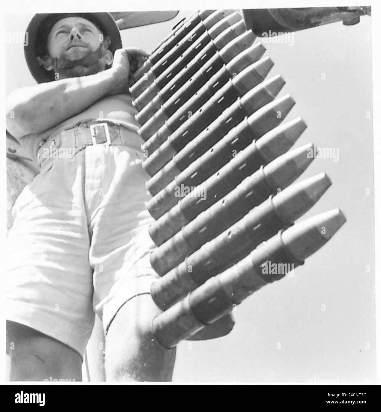 THE MEN WHO CARRY SUPPLIES TO TOBRUK - One of the crew stands 'at the ...