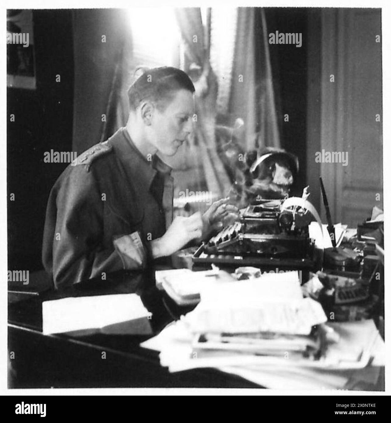 Photograph shows Capt. Warwick Charlton, editor of the 8th Army News ...