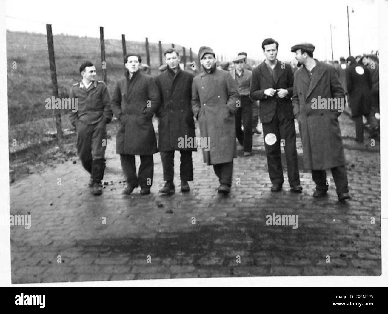 German prisoners are documented at a prisoner-of-war camp, showing ...