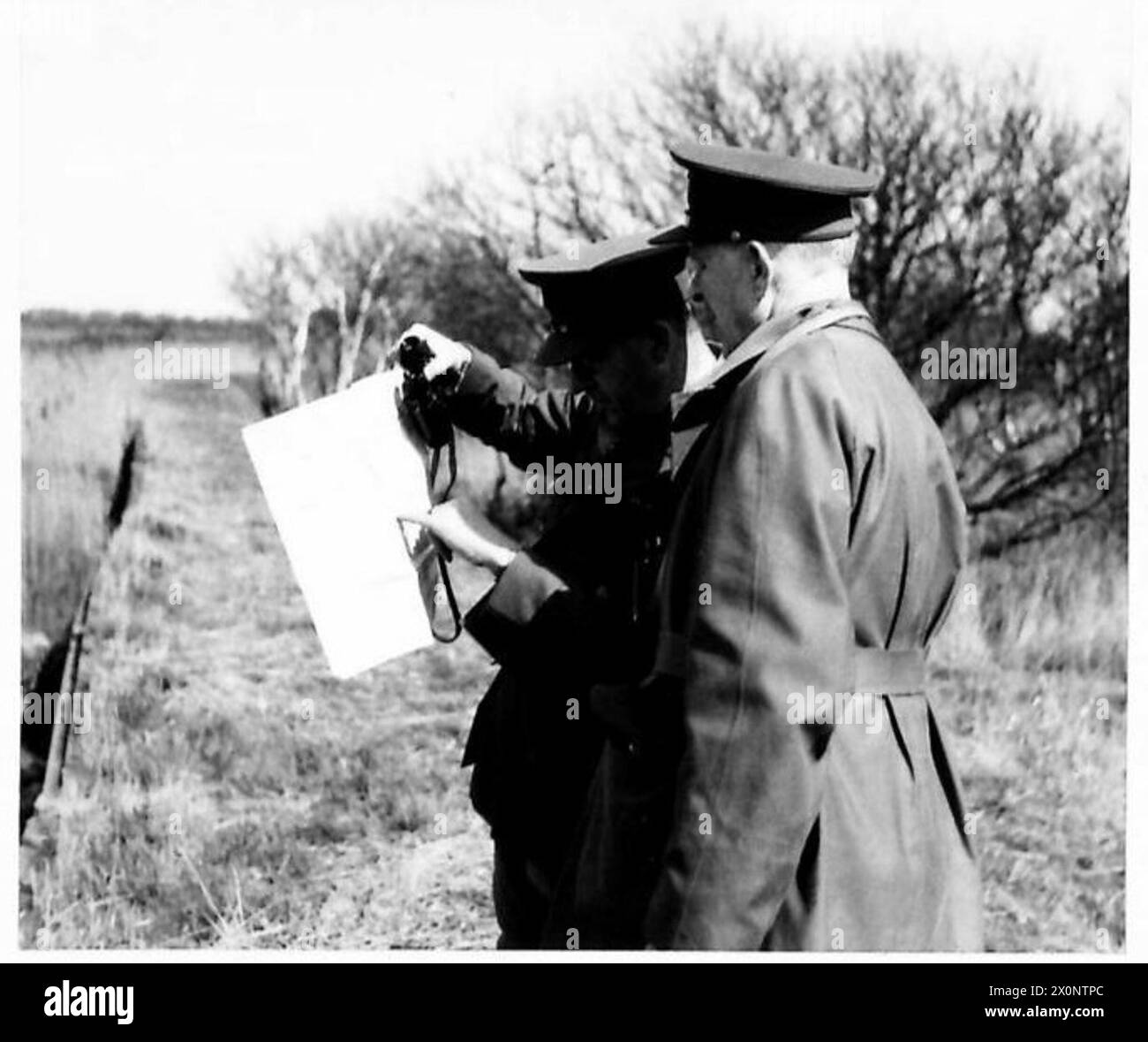 Photograph of Lord Gort reviewing plans at an artillery range, showing ...