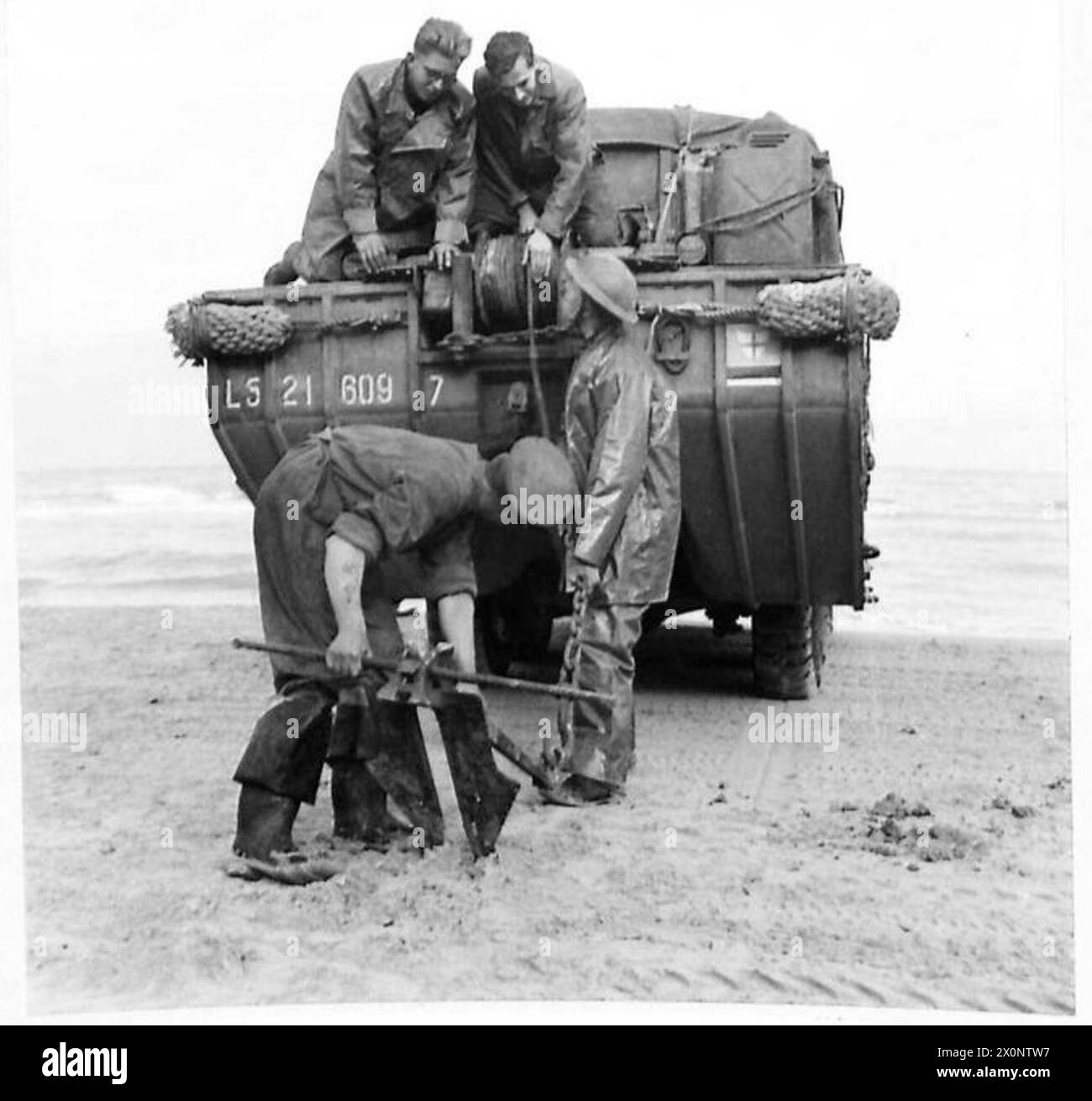 Men haul anchors aboard amphibious 'ducks' during Eighth Army ...