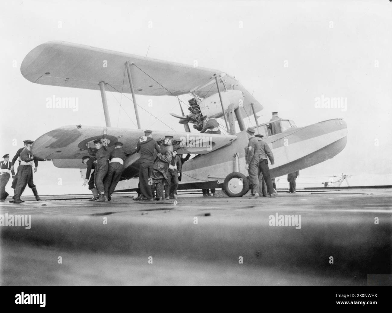 ON BOARD THE AIRCRAFT CARRIER HMS ARGUS. 1940. - A plane comes up from ...