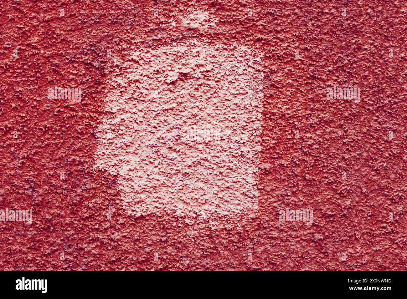 Red wall with a white square-shaped spot. Texture of old plaster with ...