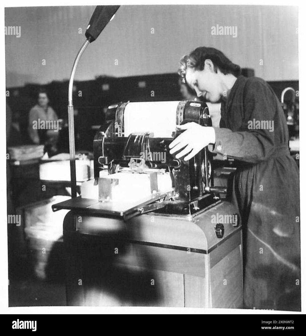 Female personnel work on a Gestetner machine in the Printing Branch at ...