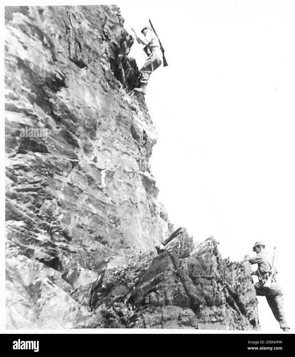 Members of a military unit, known as the Green Devils, prepare to climb ...