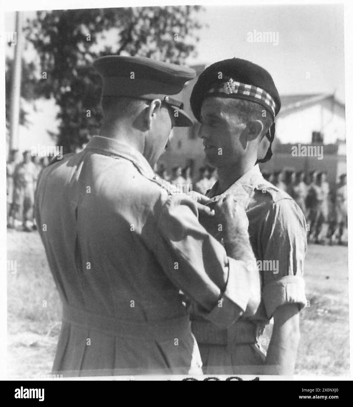 Major General Penny awards Gnr. J. Sutherland of the Scottish Regiment ...