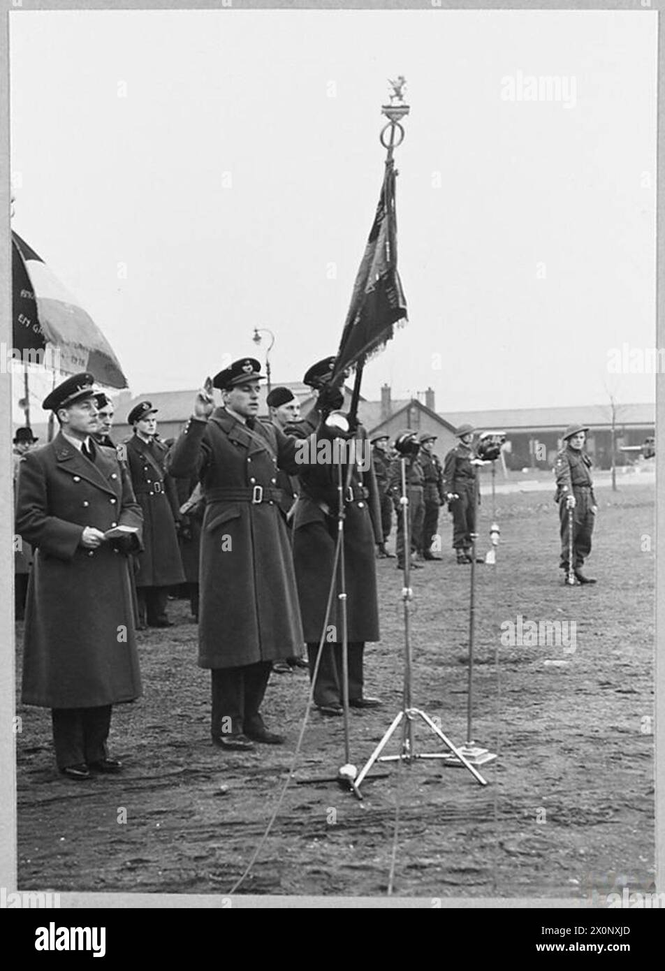 A Belgian fighter pilot touches the recovered war standard from ...