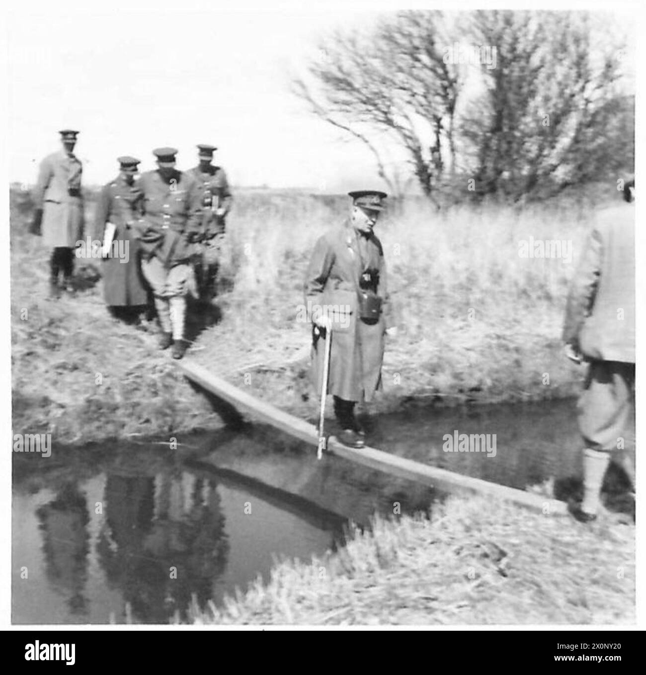 LORD GORT INSPECTS AN ARTILLERY RANGE - Lord Gort crossing a dyke by a ...